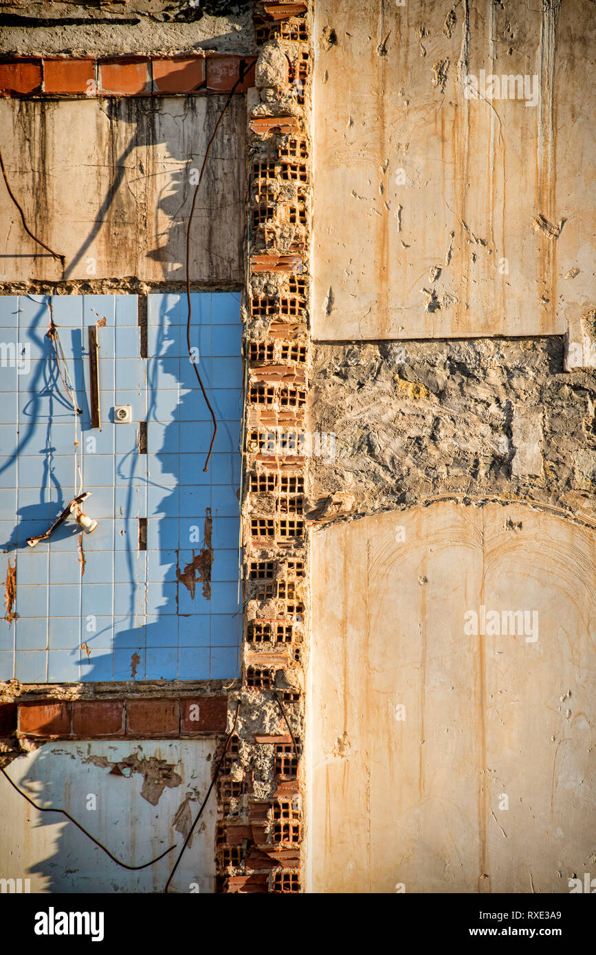 Wall left over after pulling down a house Stock Photo - Alamy