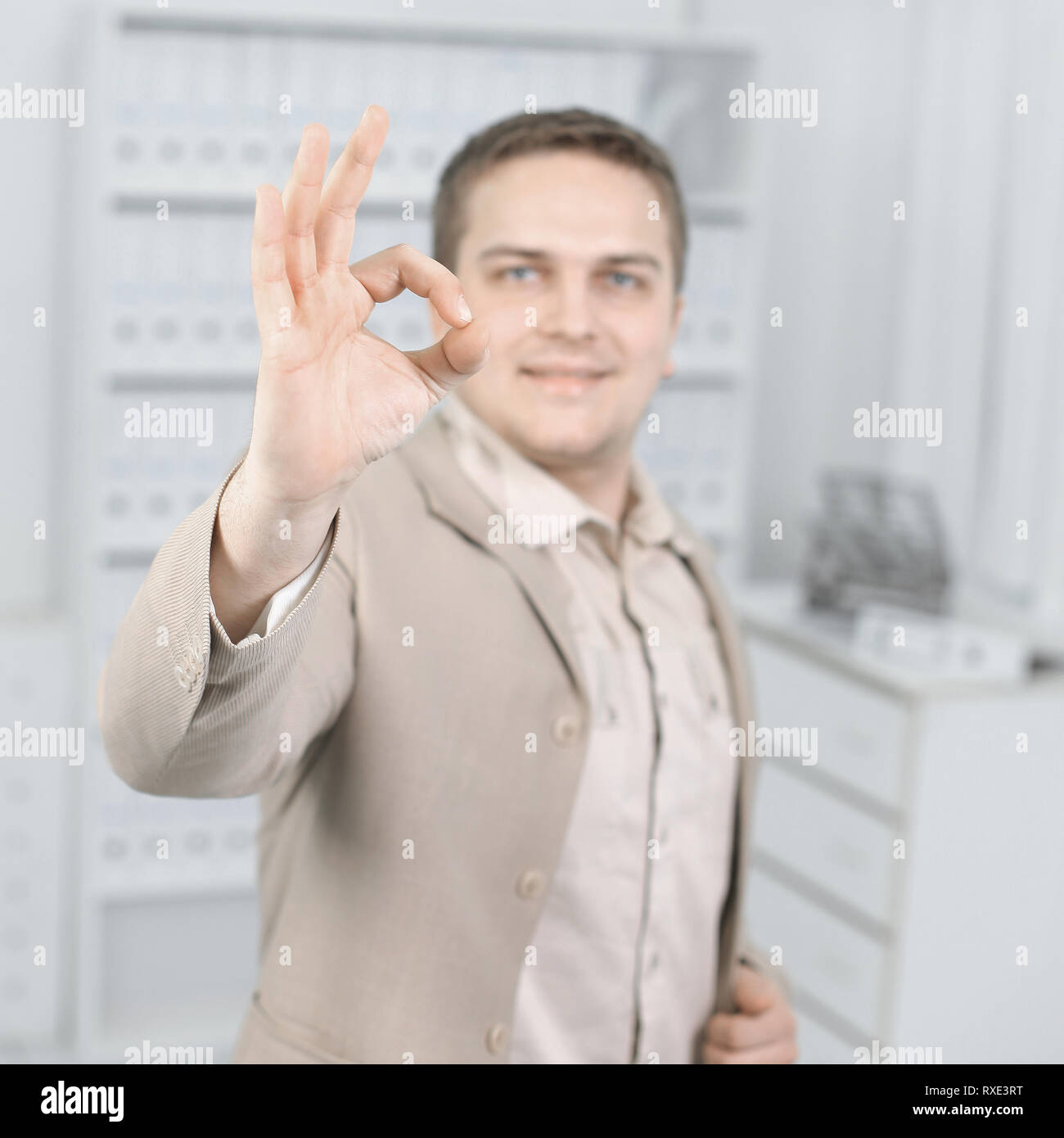 portrait of a young businessman showing OK sign Stock Photo - Alamy