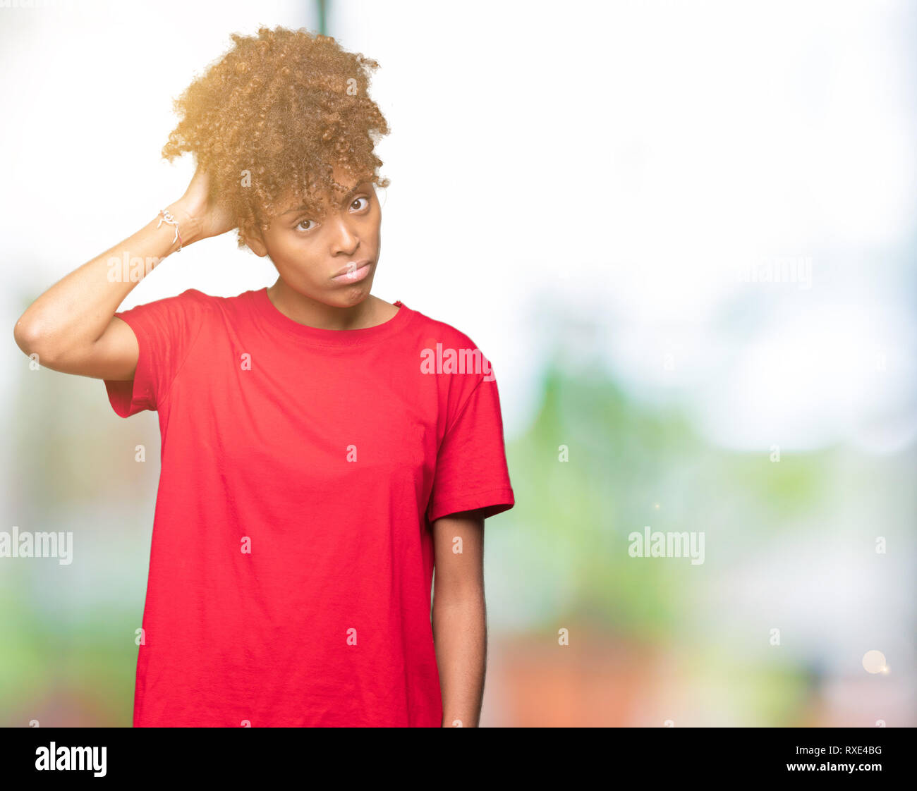 Beautiful young african american woman over isolated background confuse ...