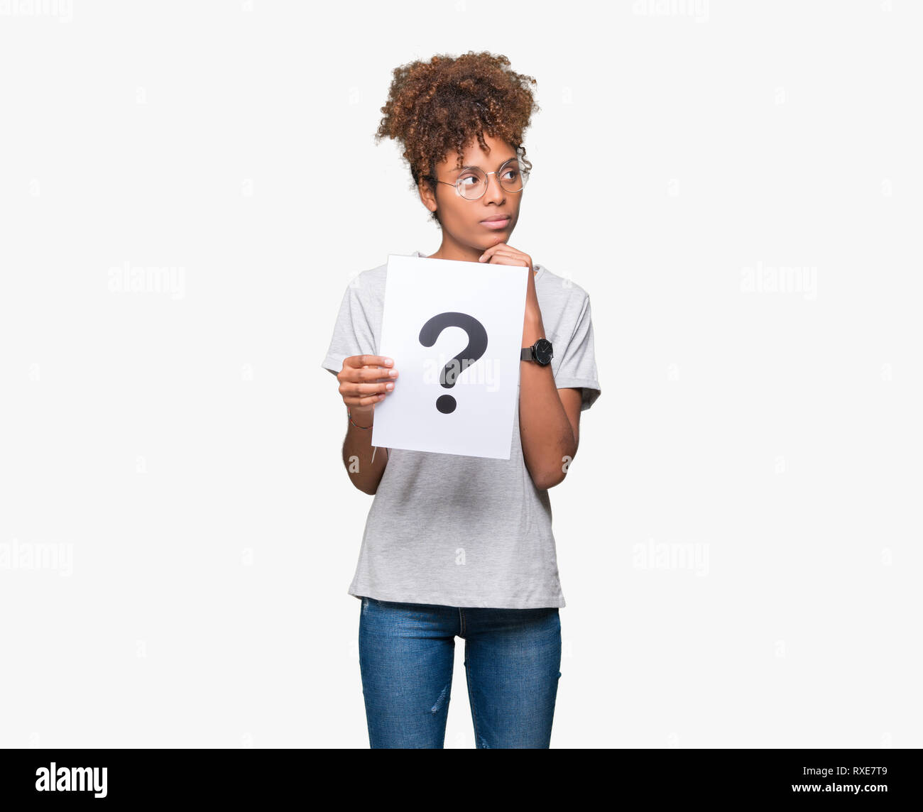 Young african american woman holding paper with question mark over ...