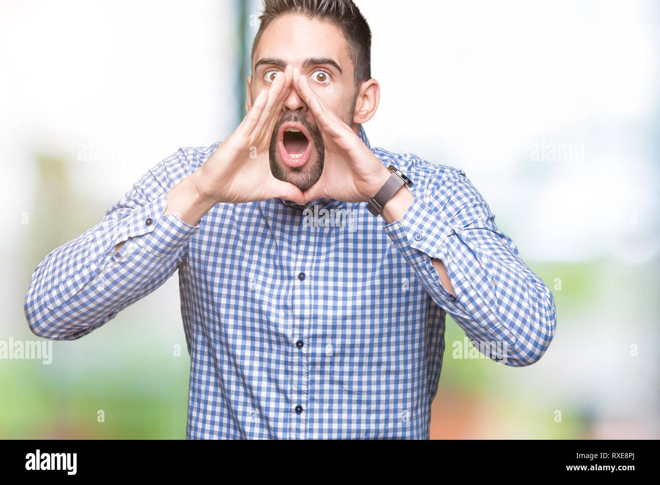 Young handsome man over isolated background Shouting angry out loud ...