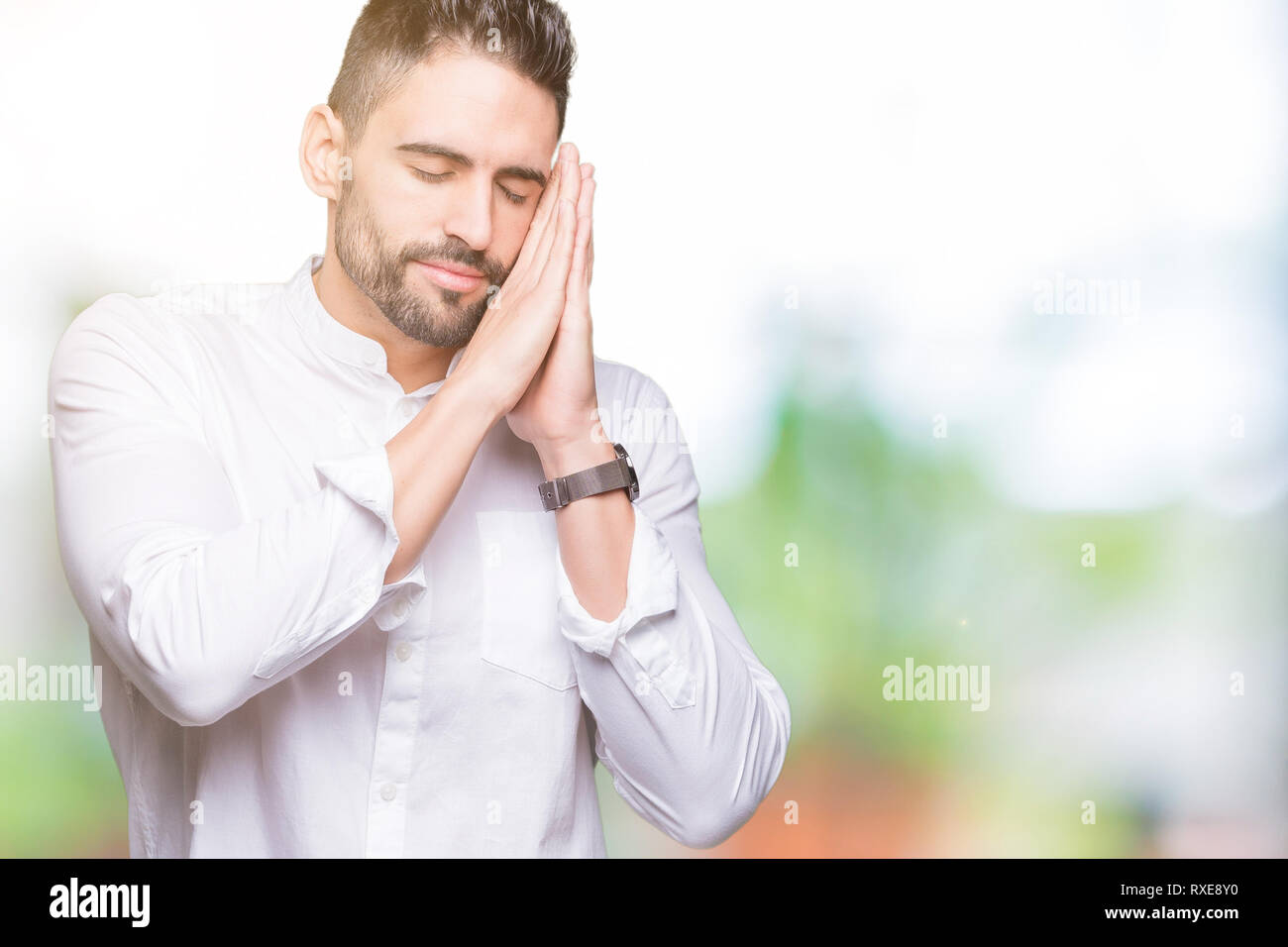 Young business man over isolated background sleeping tired dreaming and ...