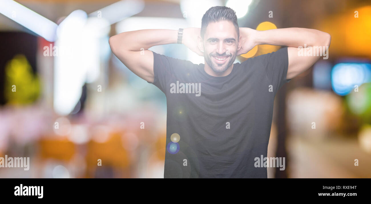 Young handsome man over isolated background Relaxing and stretching ...