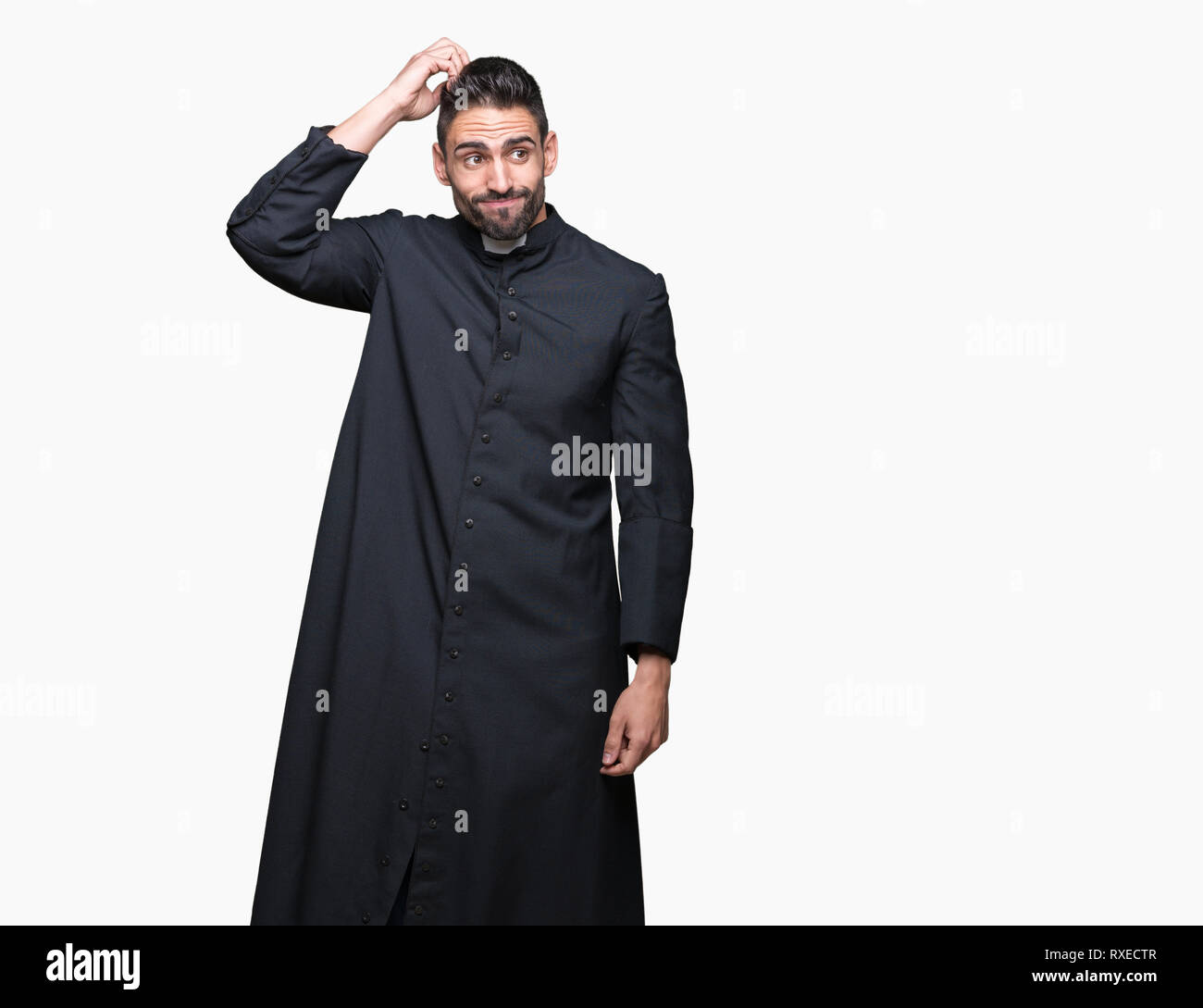 Young Christian priest over isolated background confuse and wonder ...