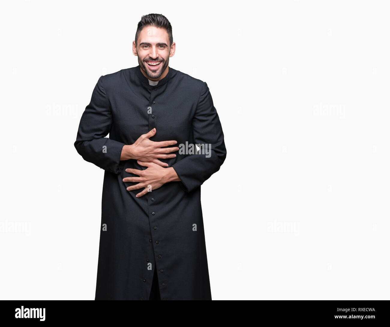 Young Christian priest over isolated background Smiling and laughing ...