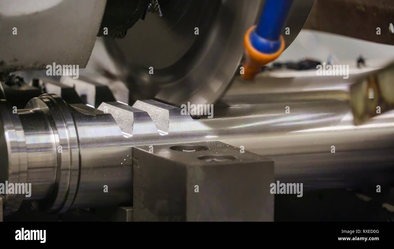 The milling of the metal tubes with the machine. The big blade of the ...