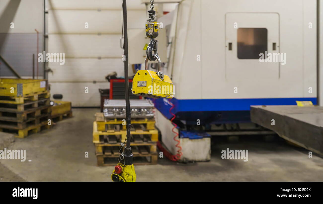 The CNC machine with a magnet hanging. On the standby inside the ...
