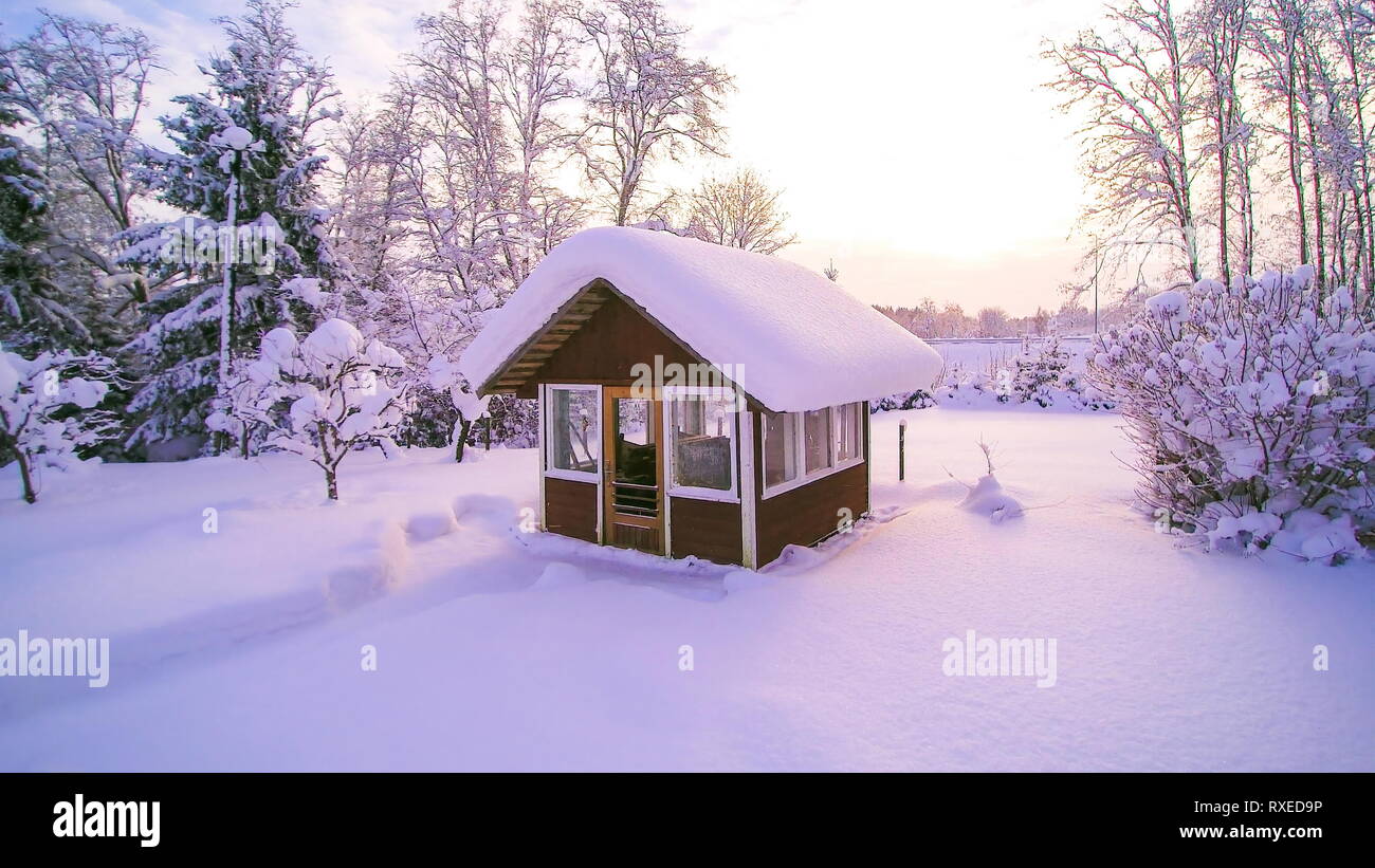 The small cottage house filled in white snow in a winter season in the ...