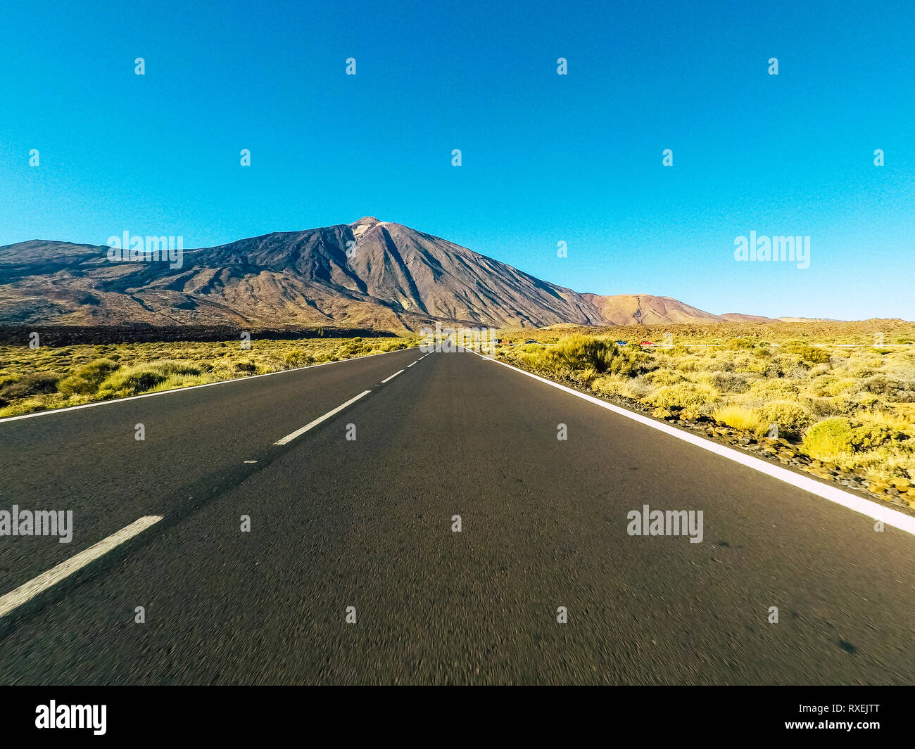 Long way road at the mountain with vulcan mount in front and blue clear ...