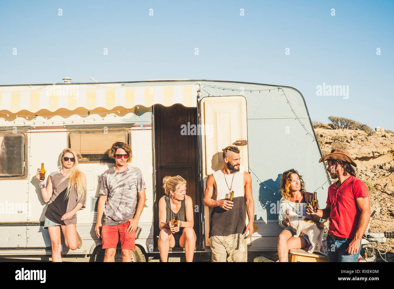 Travelers and alternative people enjoying freedom and desert outdoor ...