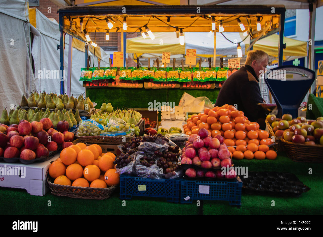 Man Working at traditional British Fruit and Veg stall Stock Photo - Alamy