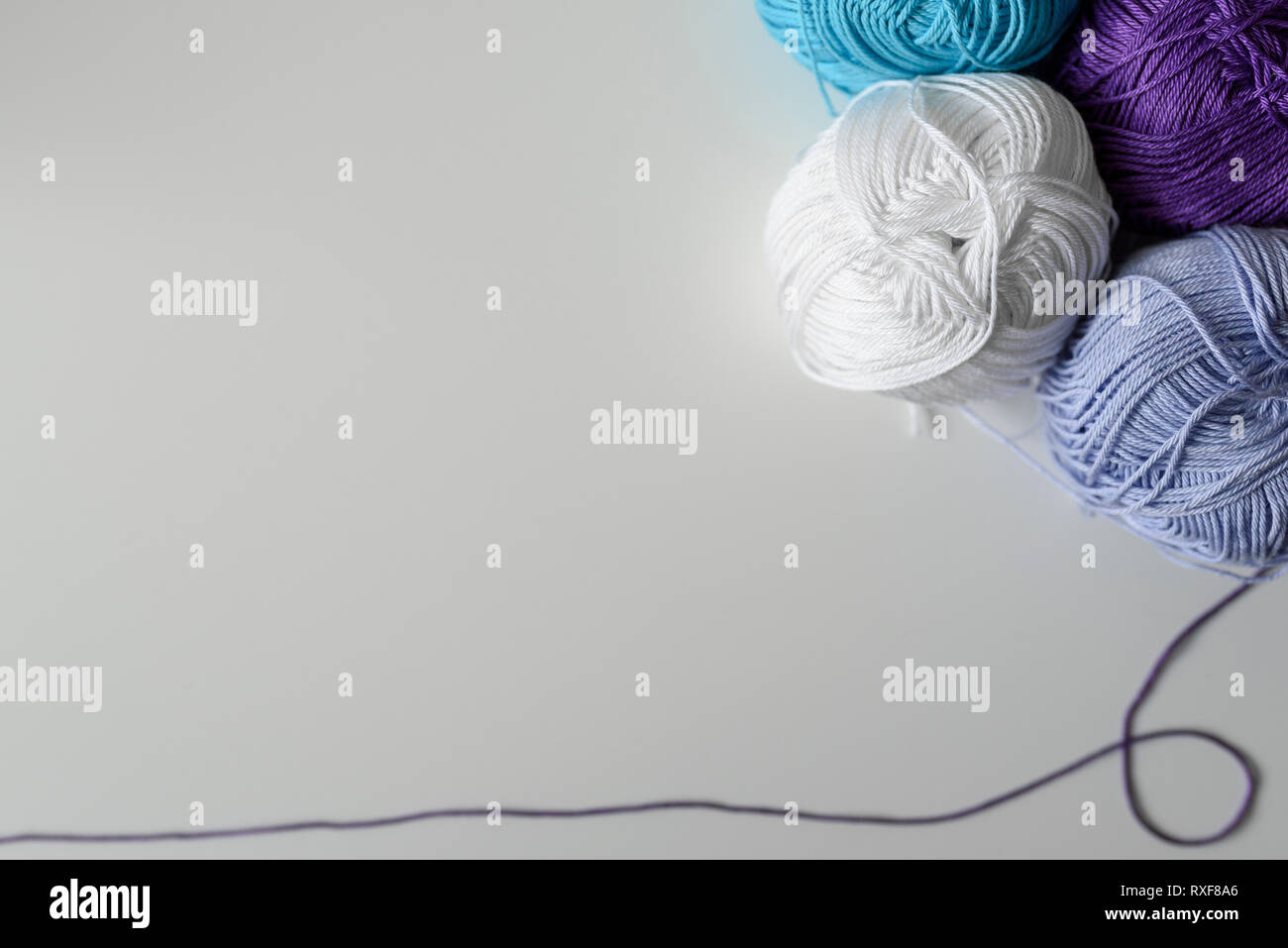 Creative handicraft background from colorful yarn balls in the corner ...