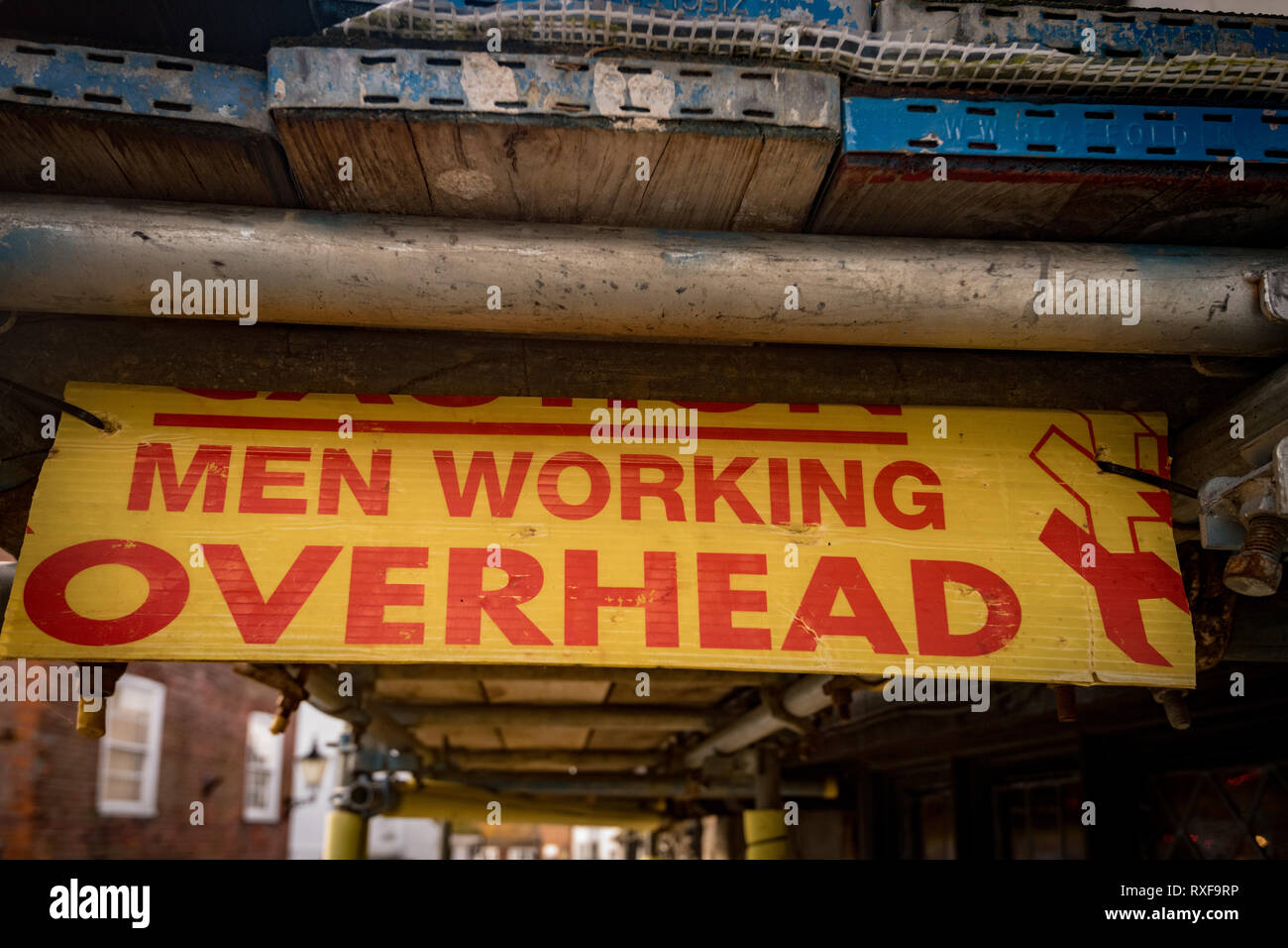 Men working overhead sign Stock Photo - Alamy