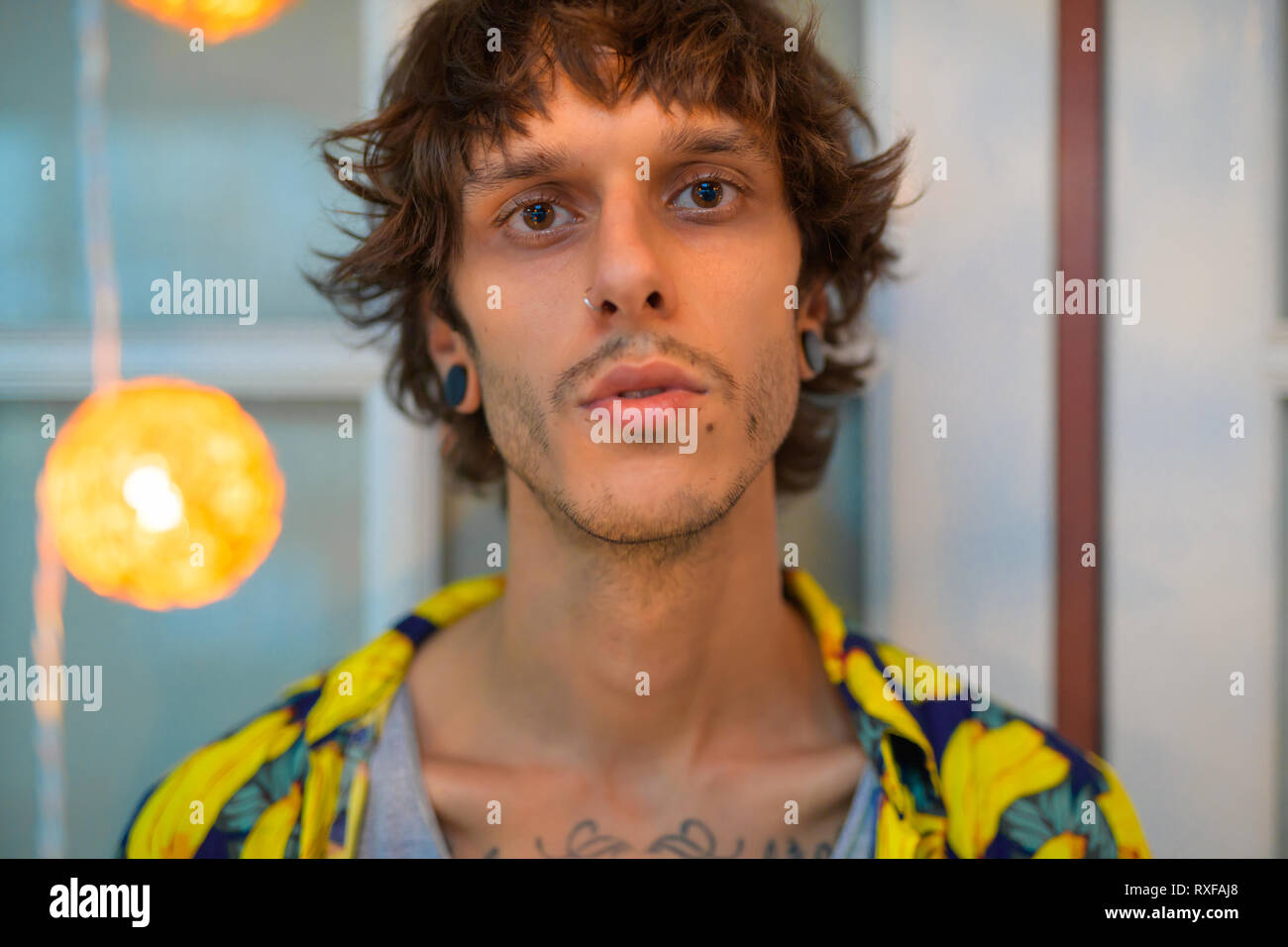 Face of young rebellious man illuminated with lights outdoors Stock ...