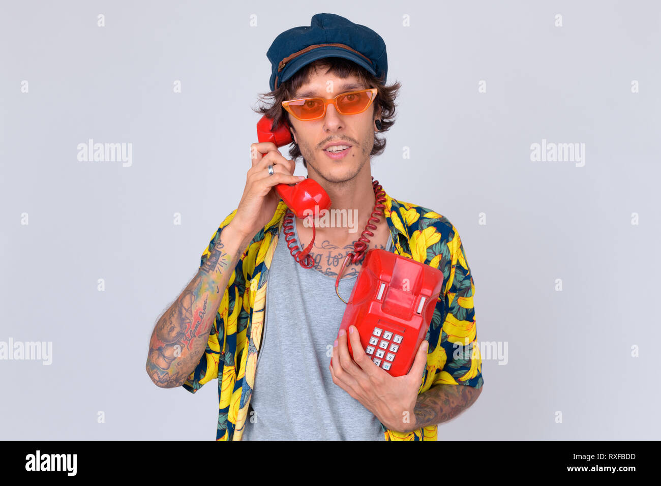 Portrait of happy young rebellious man using old telephone Stock Photo ...