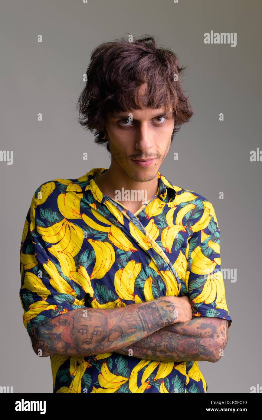 Portrait of young rebellious man with arms crossed Stock Photo - Alamy