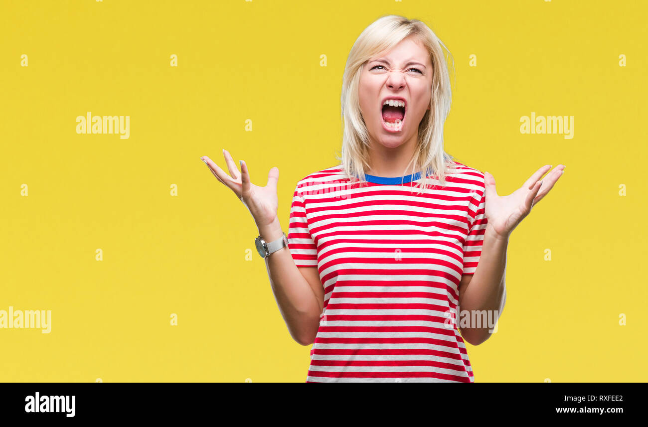 Young beautiful blonde woman over isolated background crazy and mad ...