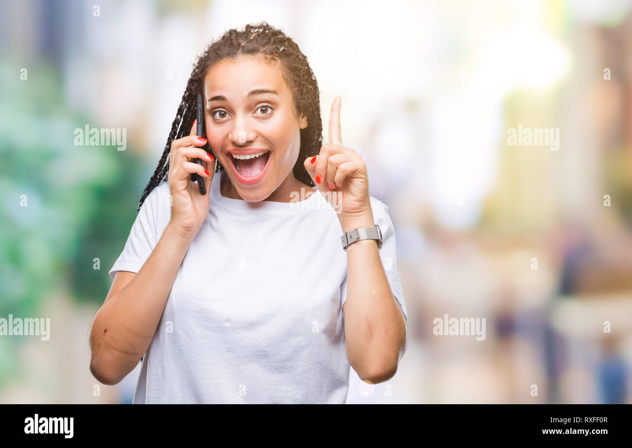 Young braided hair african american girl showing calling using ...