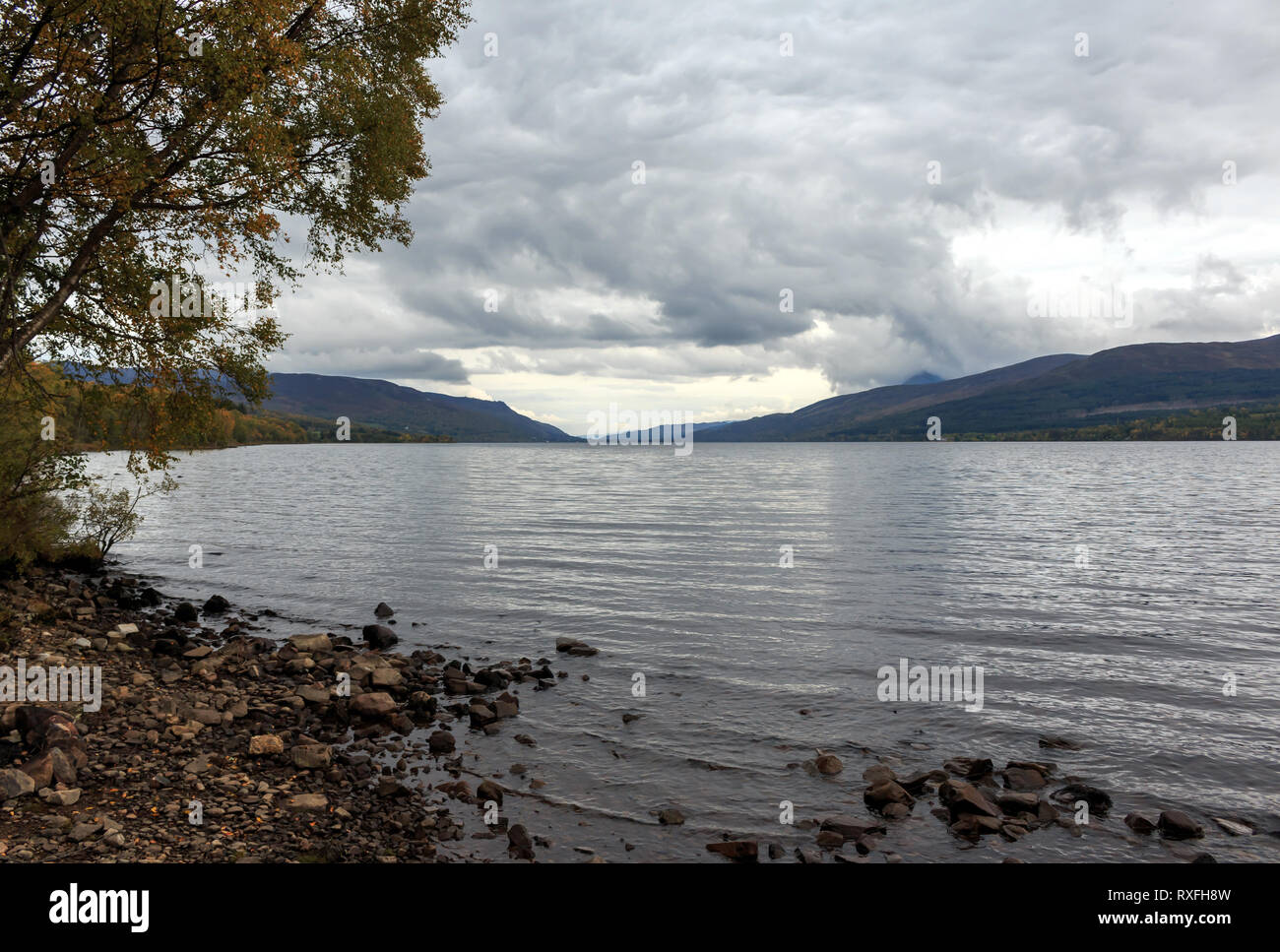 shoreline view with rocks of Loch Rannoch Scotland and the a distant ...