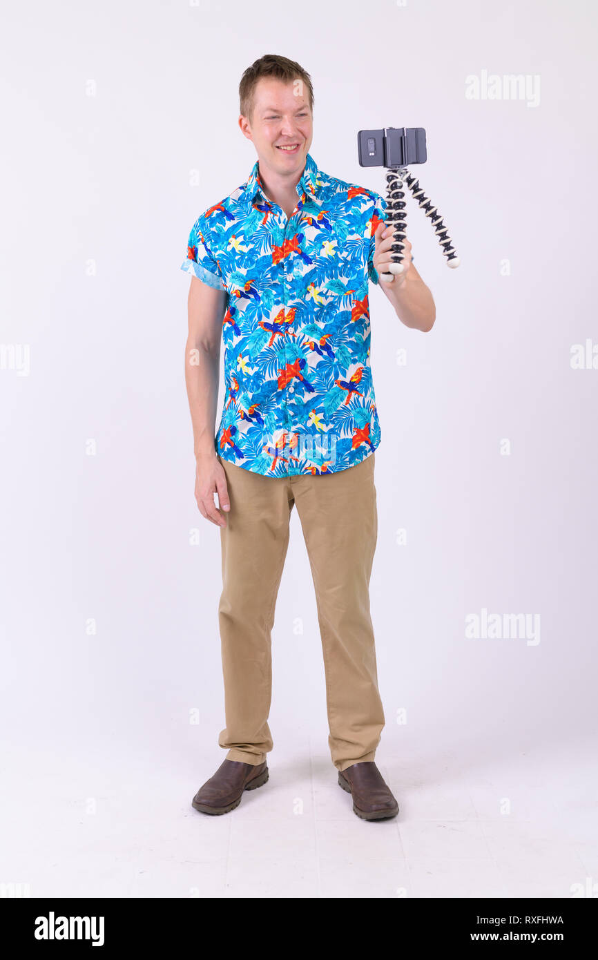 Full body shot of young happy tourist man vlogging with phone Stock ...