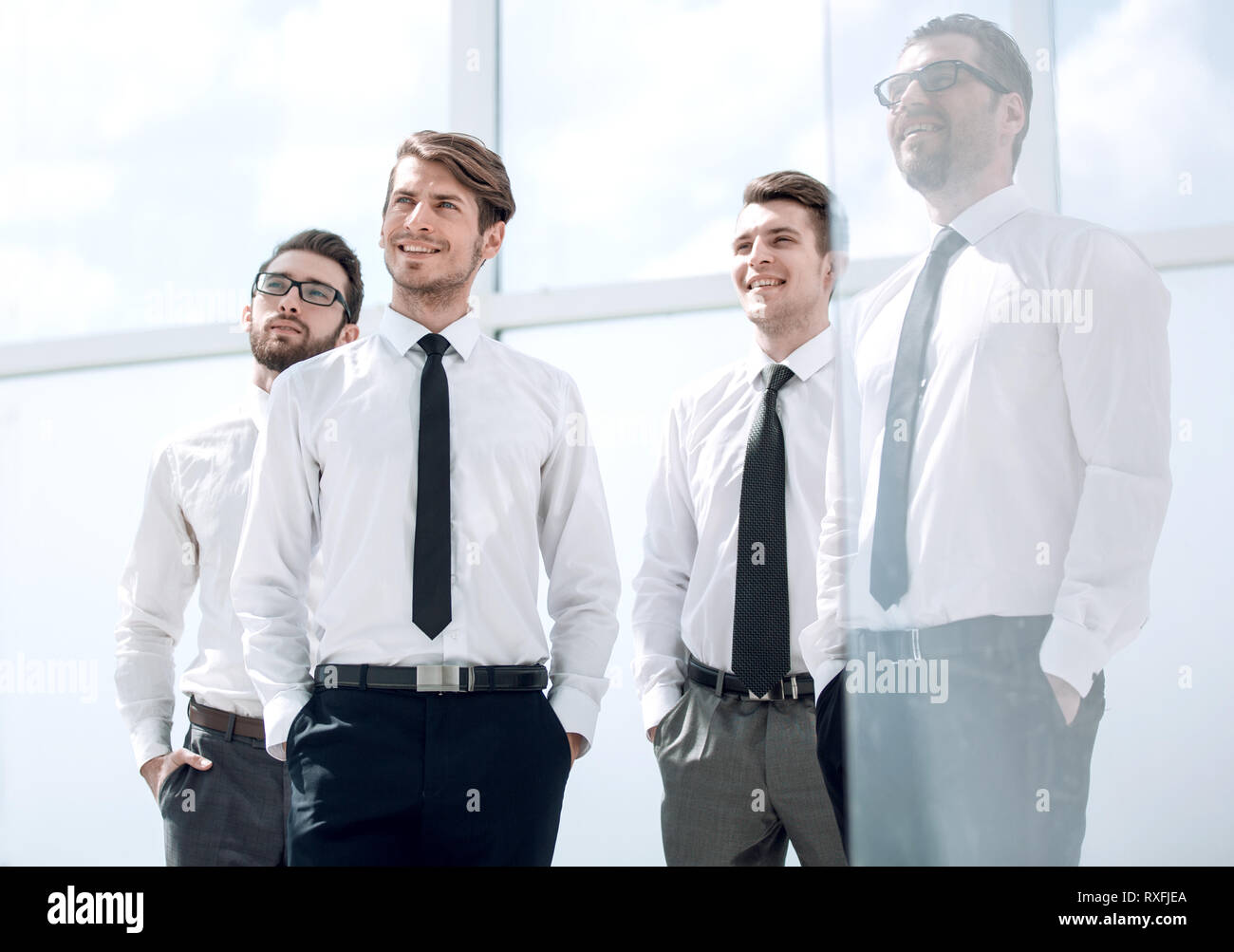 successful employees standing near the office window Stock Photo - Alamy