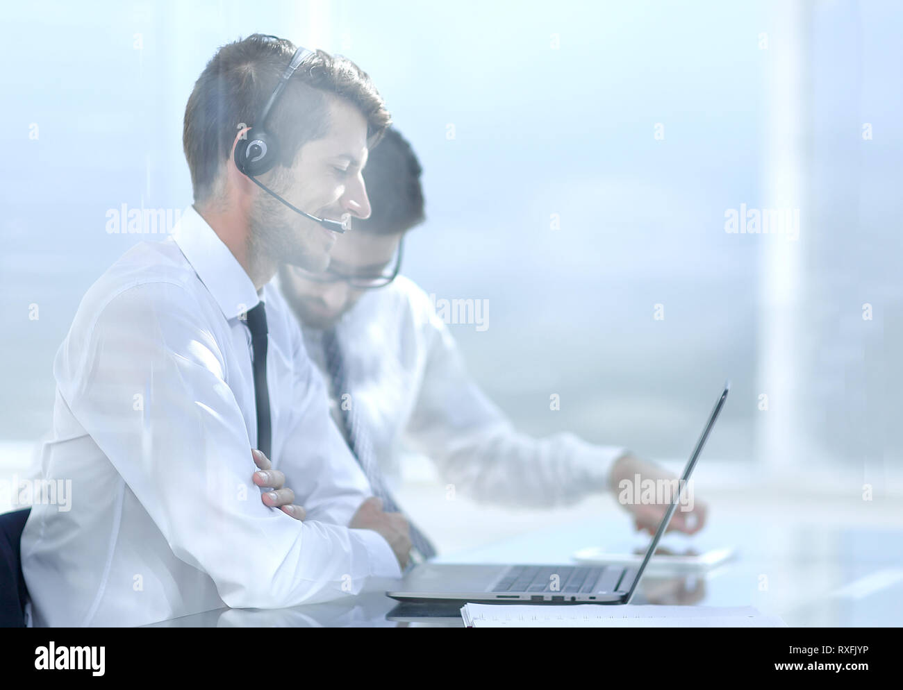 side view.consultants of the company sitting at the Desk Stock Photo ...