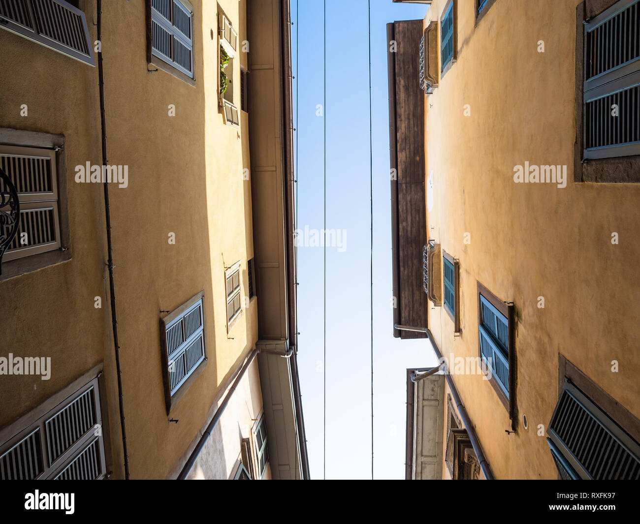 Travel to Italy - bottom view of blue sky between apartment houses on ...