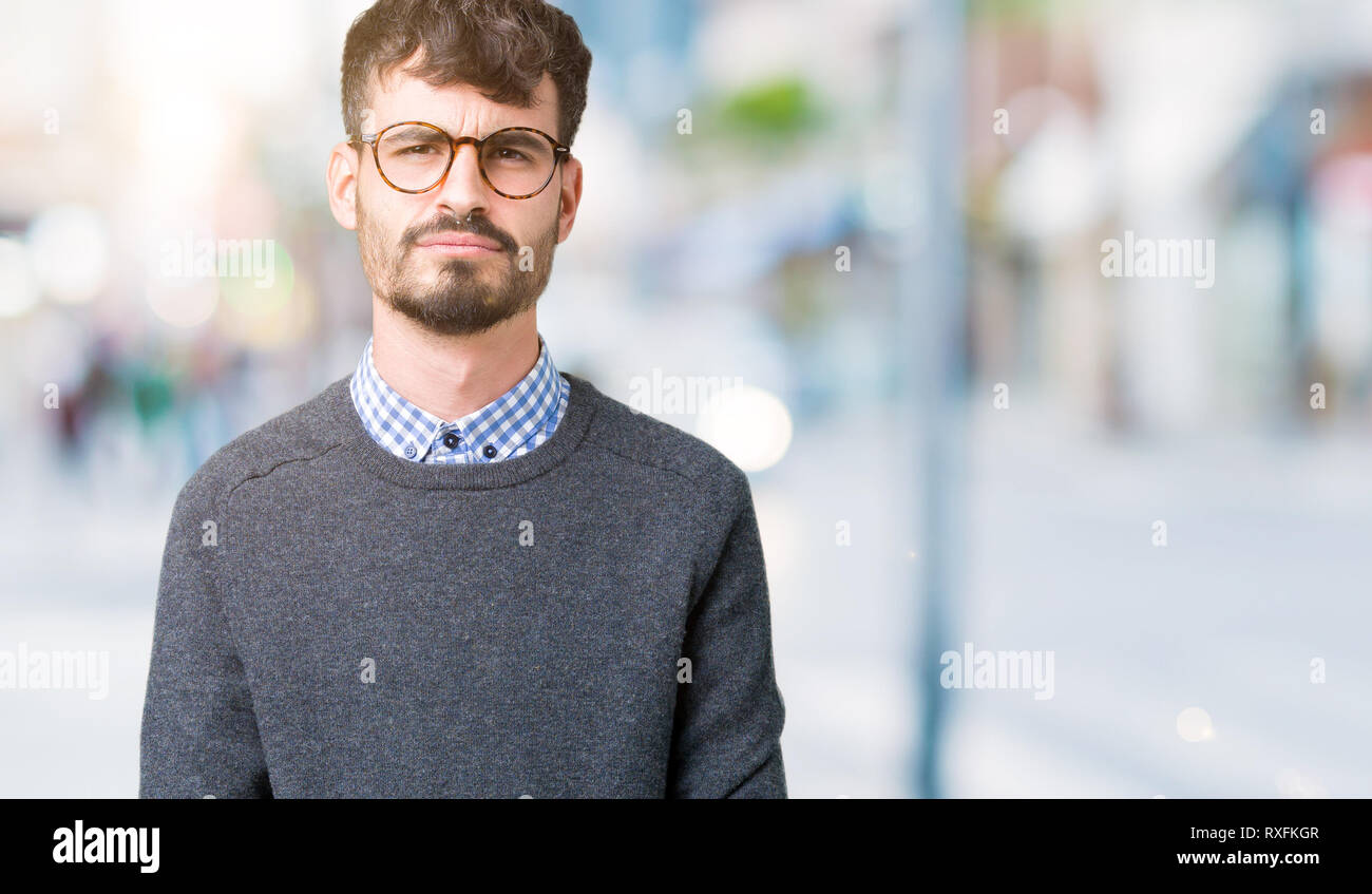 Young handsome smart man wearing glasses over isolated background ...