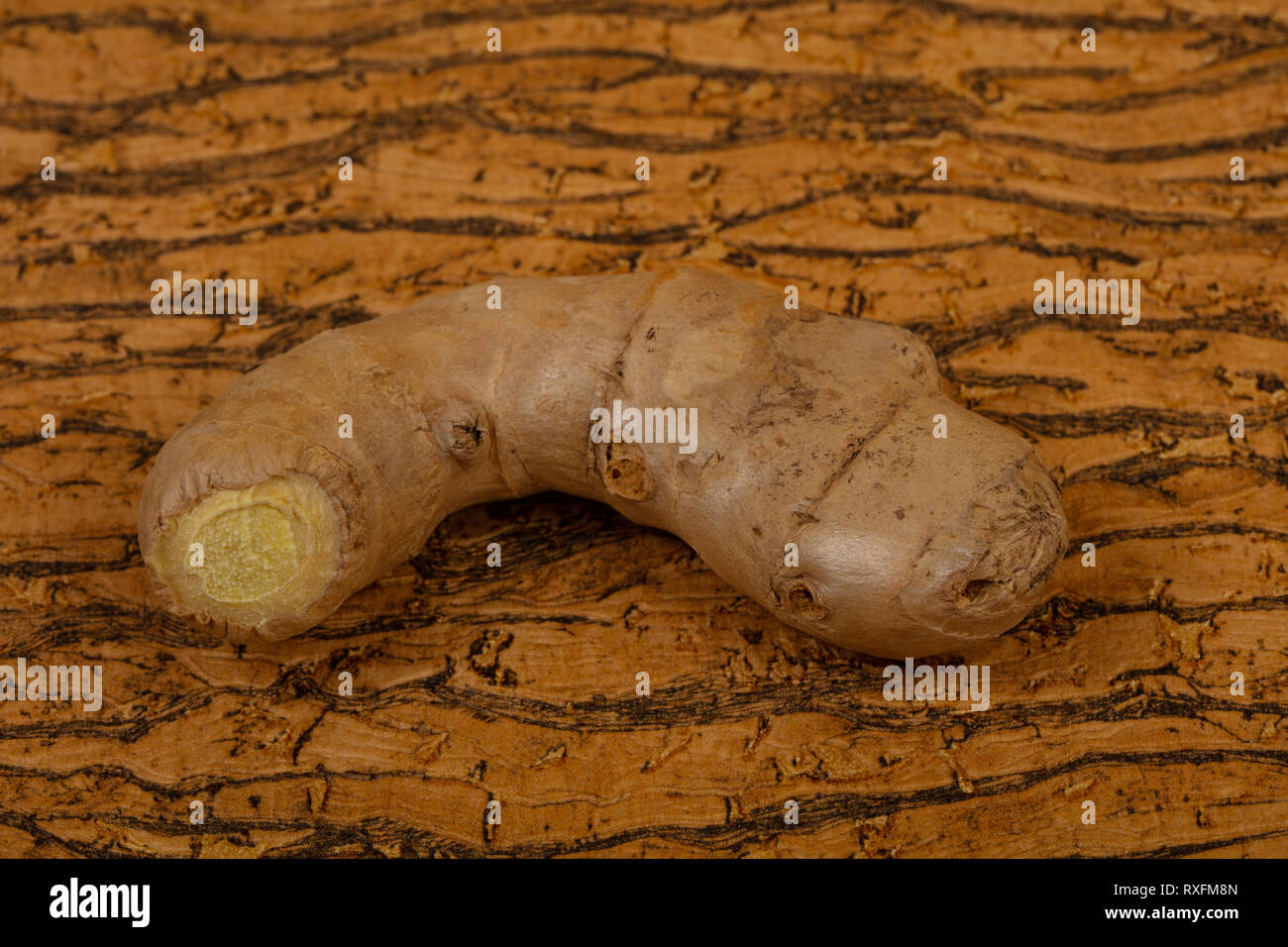 Ginger root over the wooden background Stock Photo - Alamy