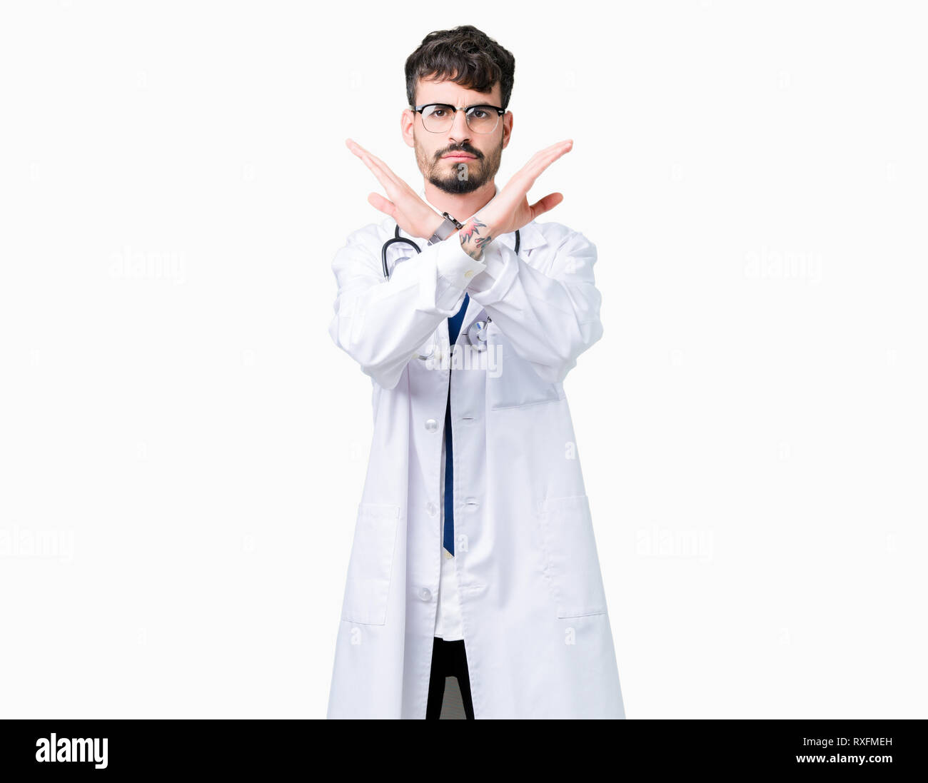 Young doctor man wearing hospital coat over isolated background ...