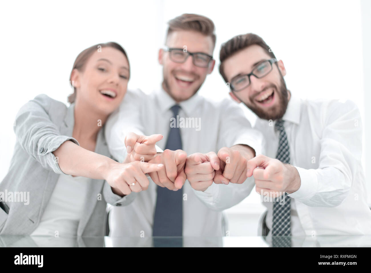 close up.a smiling business team pointing at you Stock Photo - Alamy