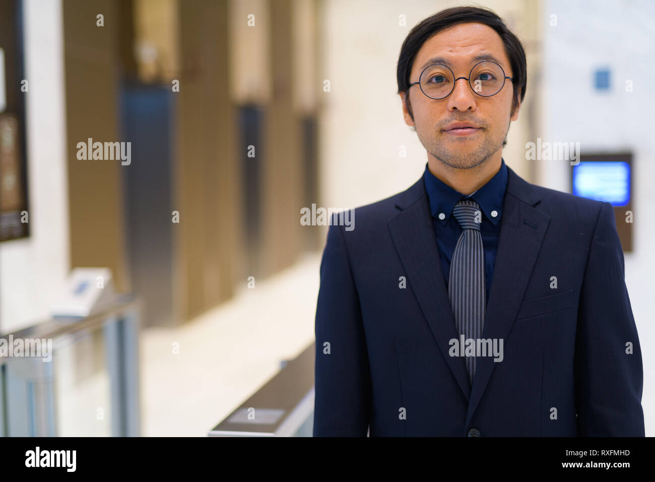 Asian businessman in the reception hall of the office building Stock ...