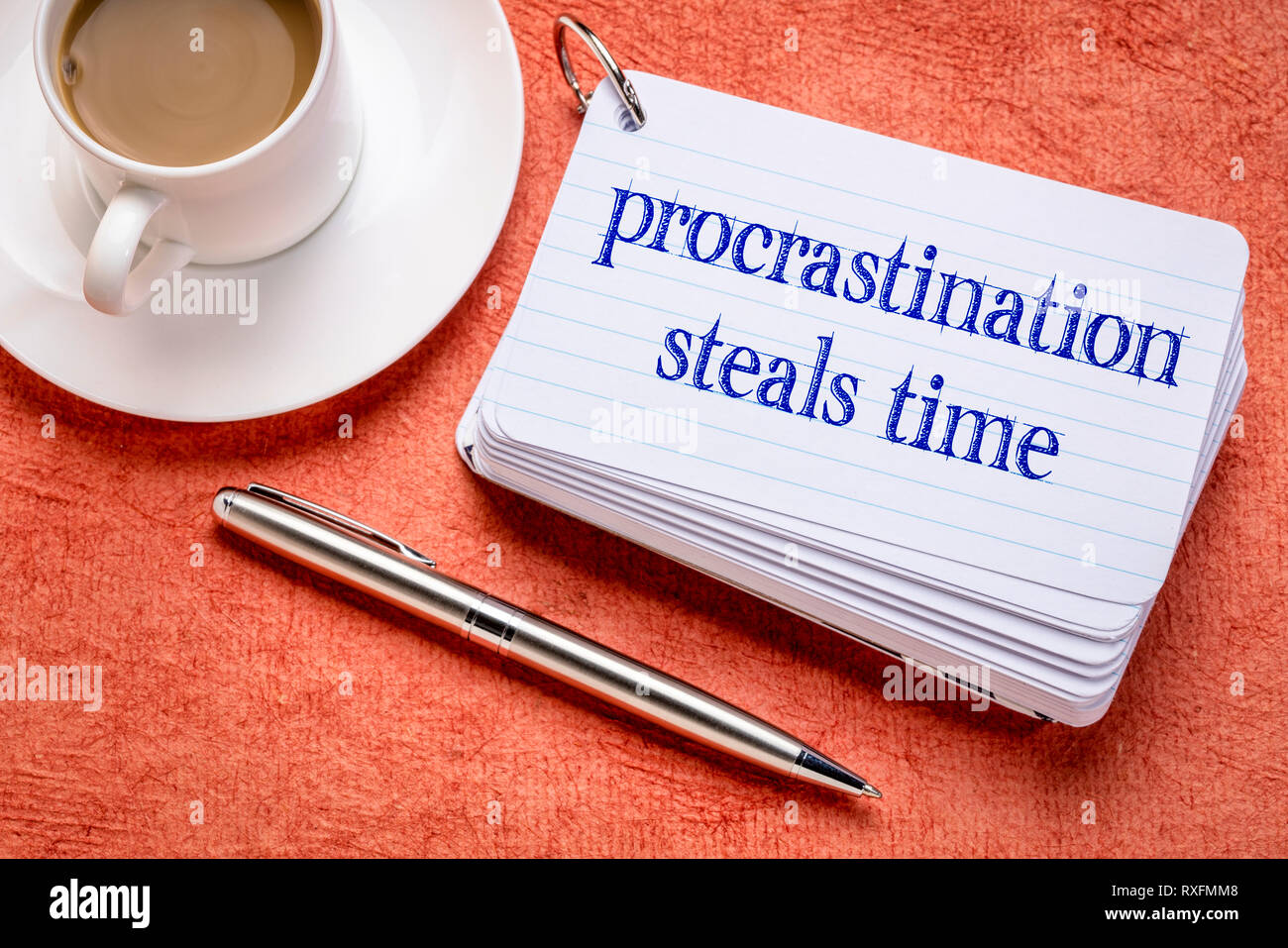 procrastination steals time reminder on a stack of index cards with a ...