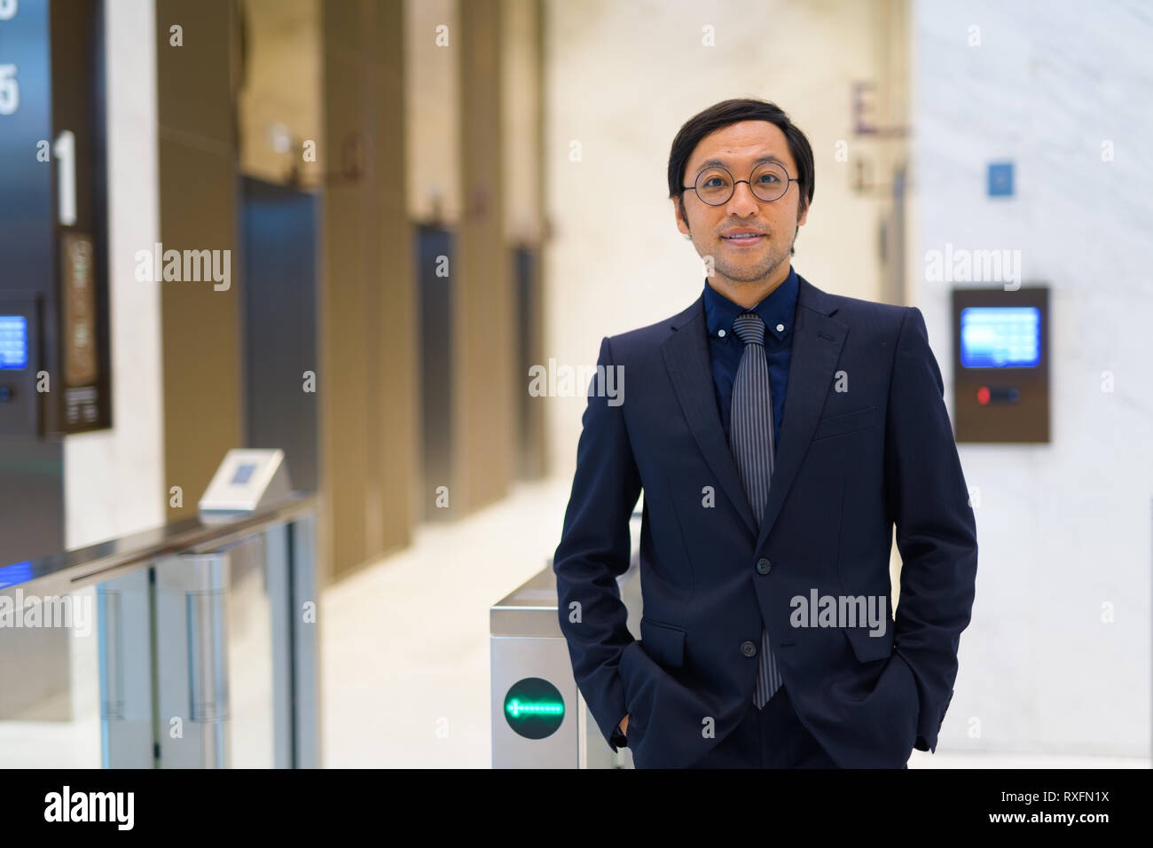 Asian businessman in the reception hall of the office building Stock ...