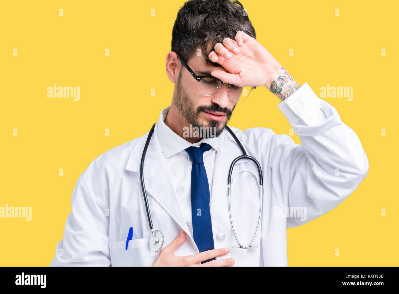 Young doctor man wearing hospital coat over isolated background ...