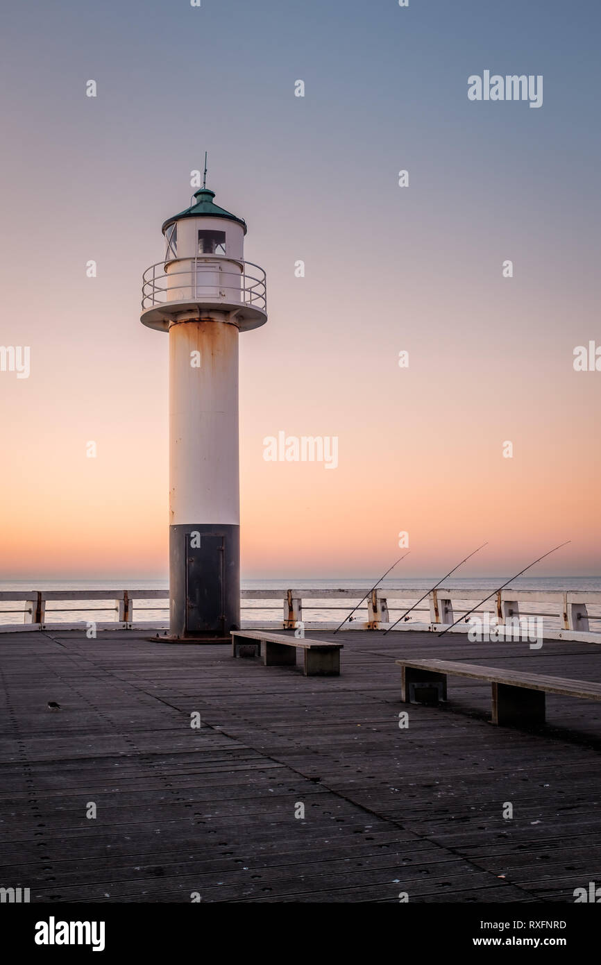 Old lighthouse of Nieuwpoort (Belgium) with three fishing rods at ...