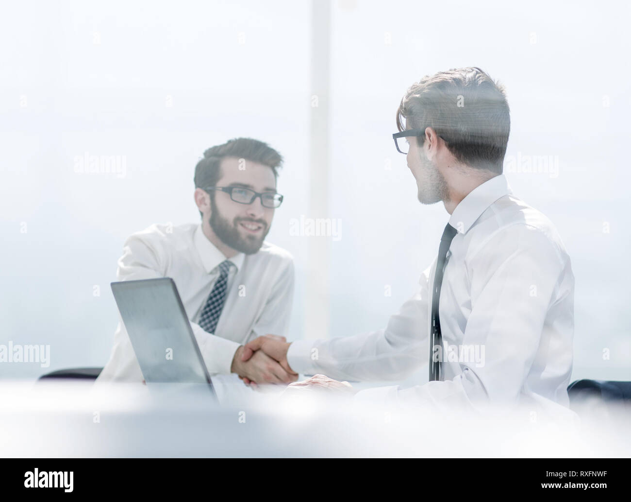 employees shaking hands at the Desk Stock Photo - Alamy