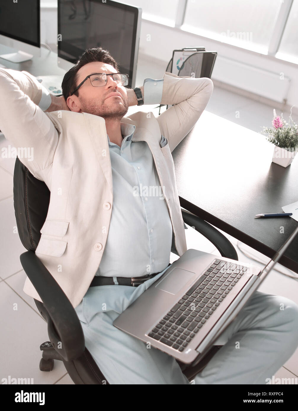 tired businessman sitting in front of his Desk Stock Photo - Alamy