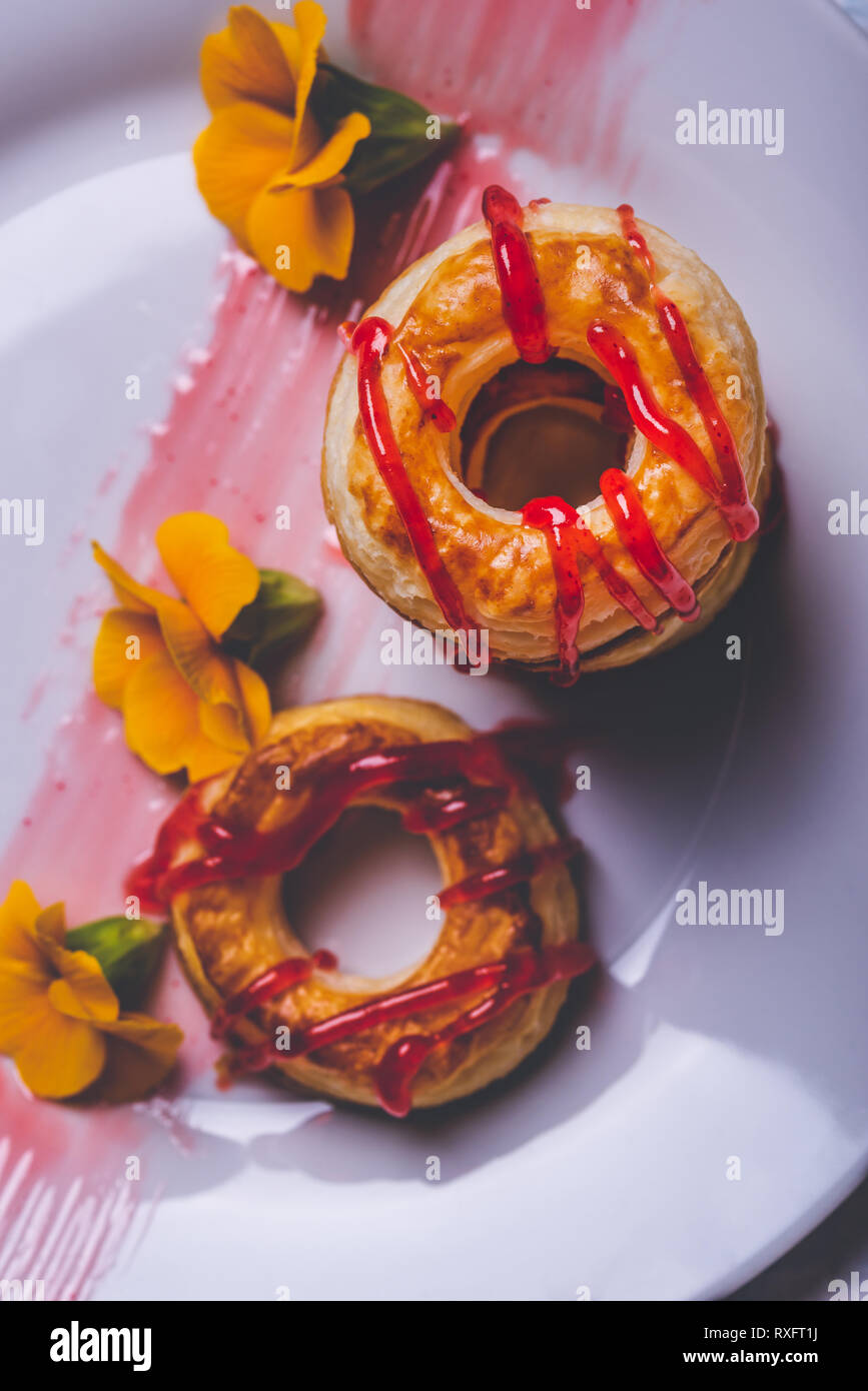 Vertical photo with top view on several donuts made from puff pastry ...