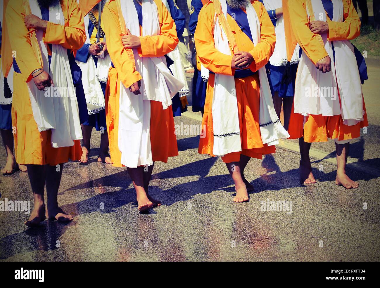 barefoot Sikh religion men during the parade in the city streets and ...