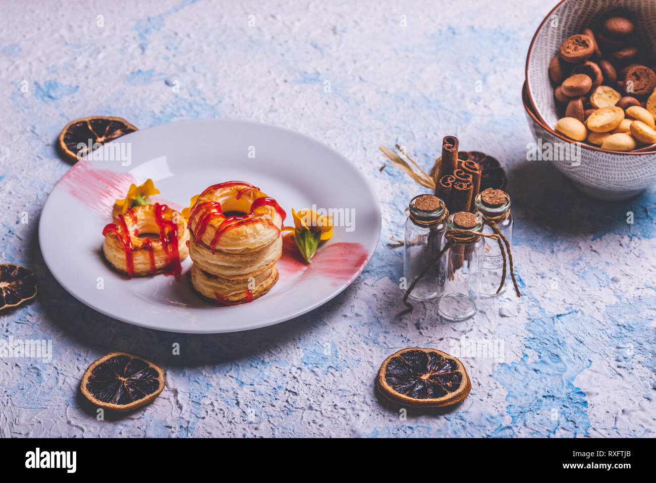 Horizontal photo with several donuts made from puff pastry dough. Red ...