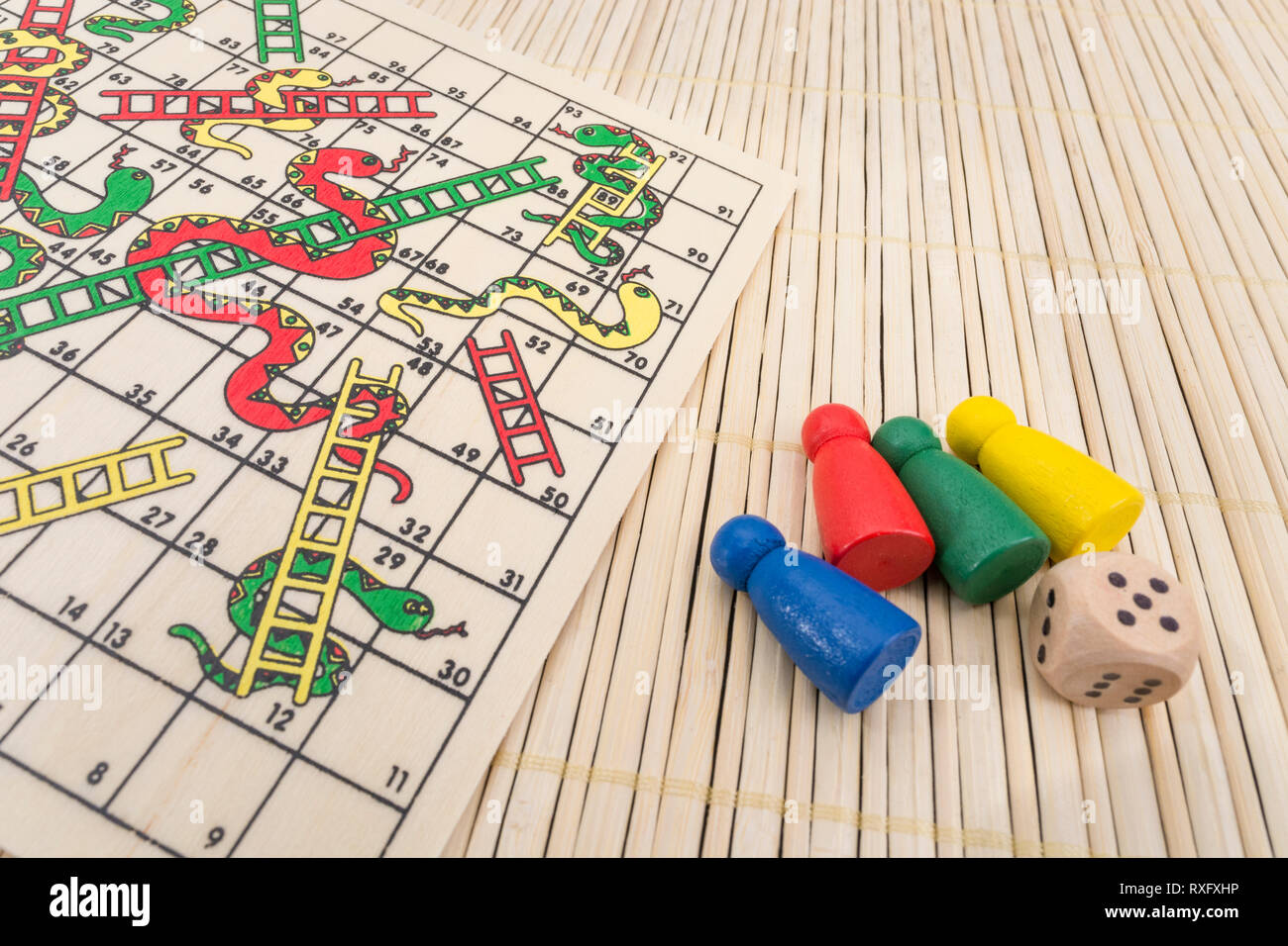 Close-up of small Snakes and Ladders game / board game For climbing ...