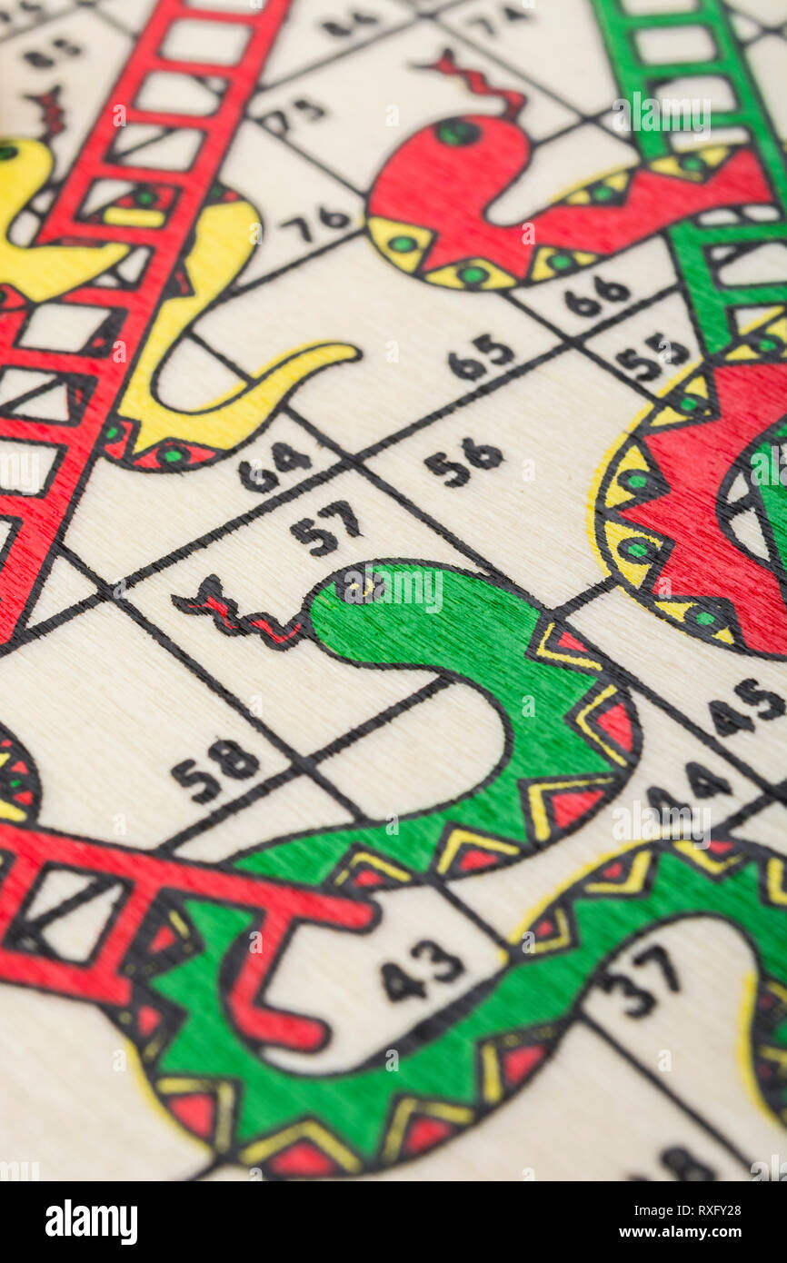 Close-up of small Snakes and Ladders game / board game For climbing ...