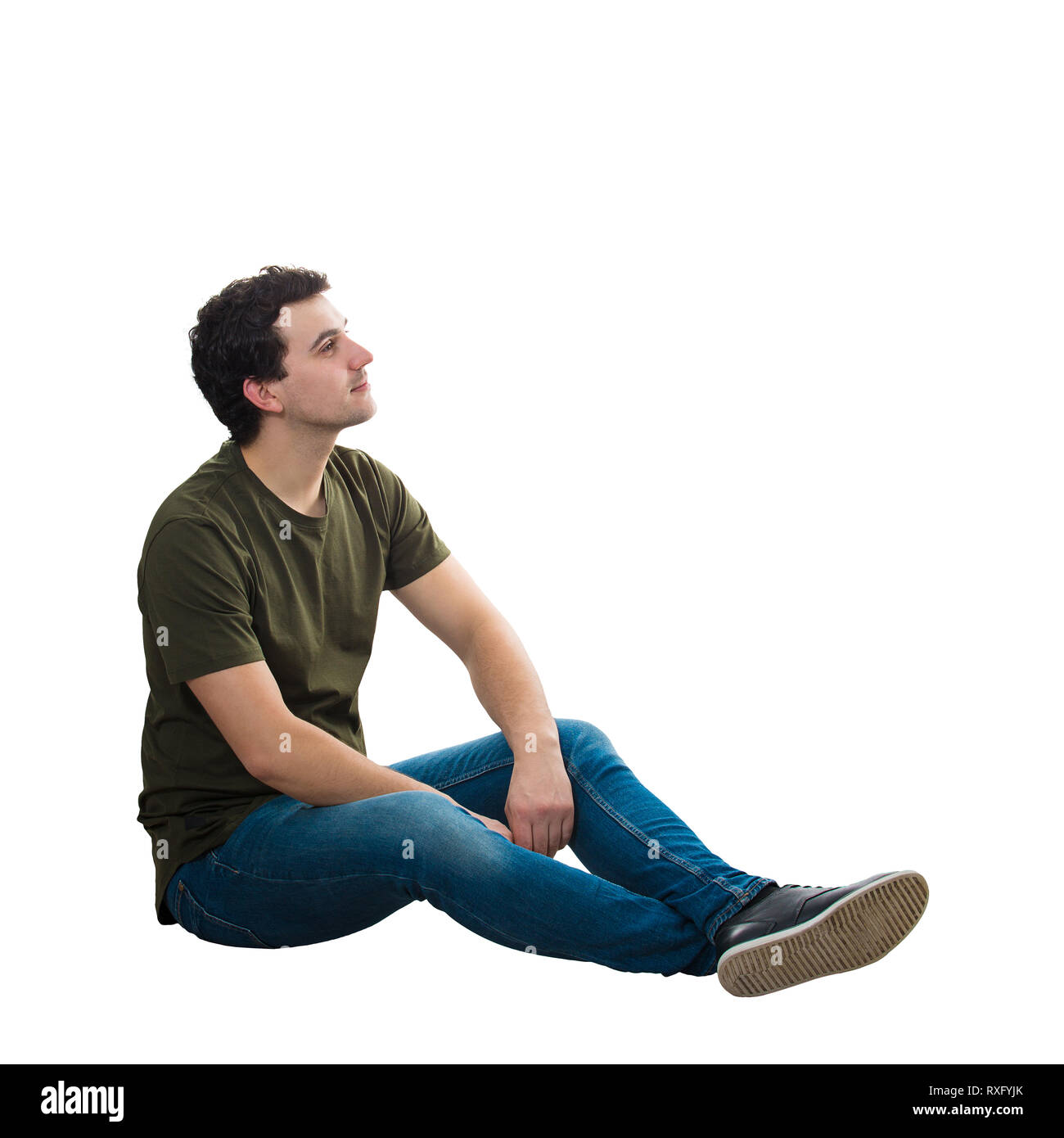 Side view handsome young man wearing casual jeans and t-shirt, sitting ...