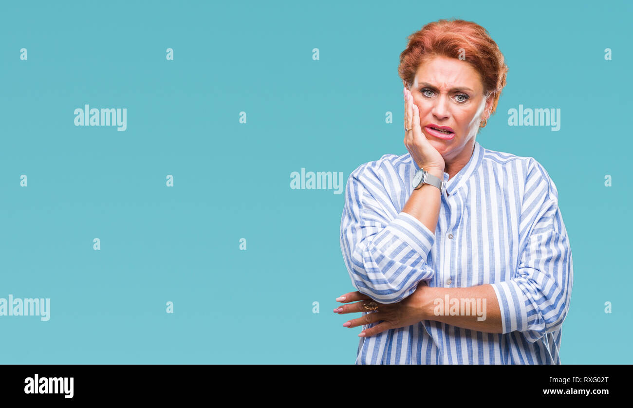 Atrractive senior caucasian redhead woman over isolated background ...