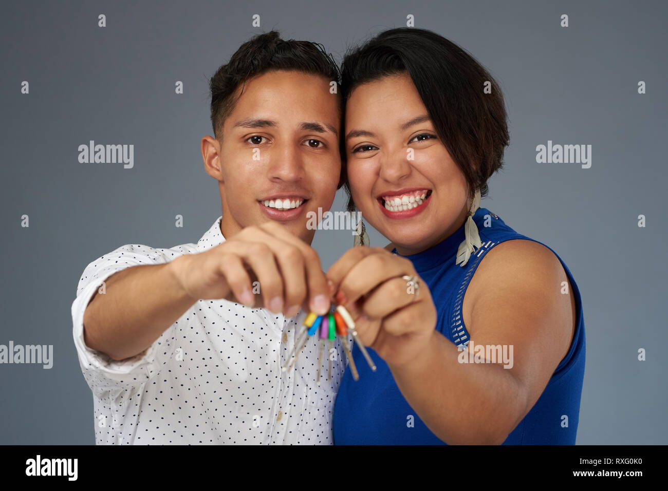 Handsome excited couple holding hi-res stock photography and images - Alamy