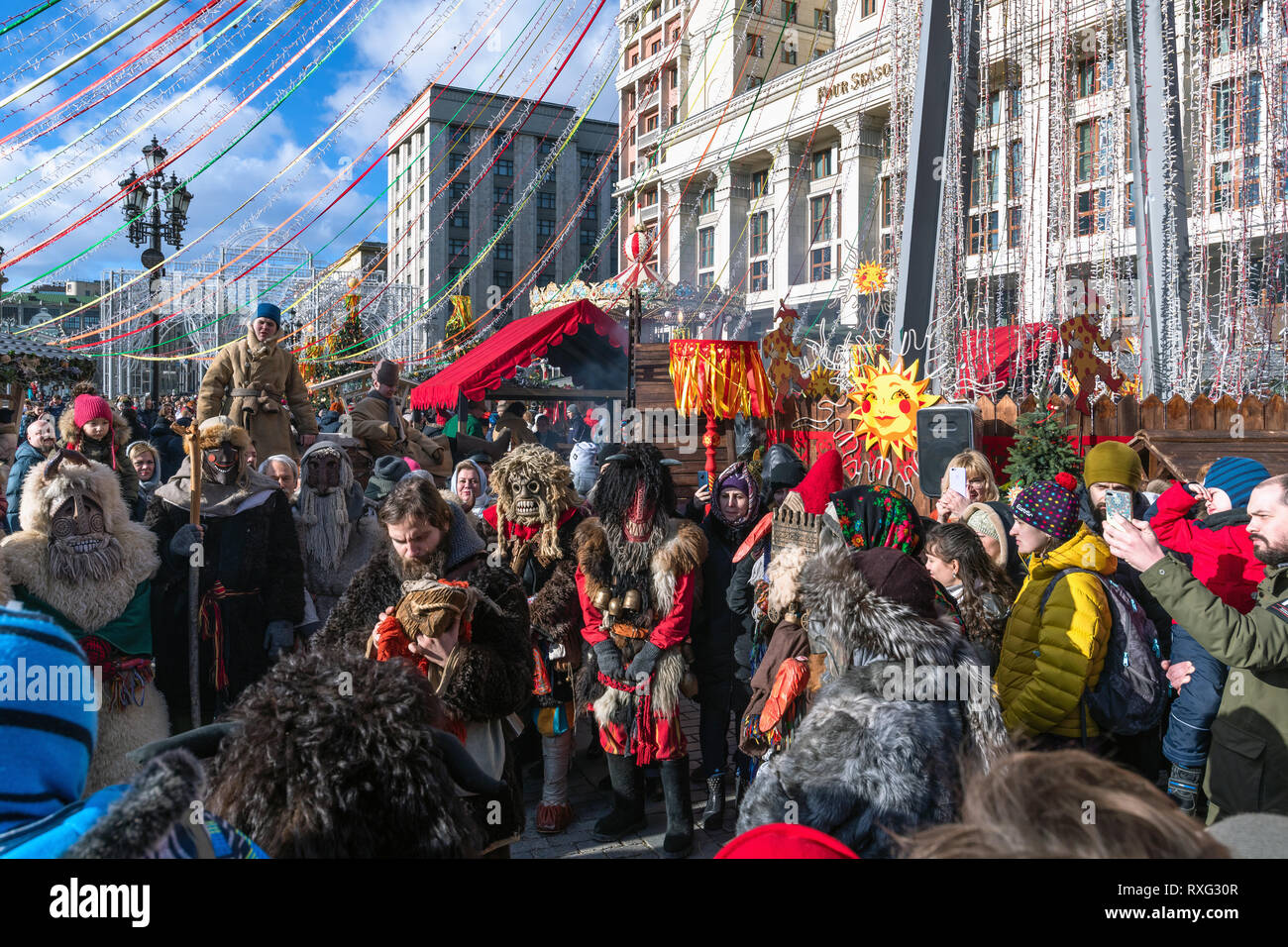 Moscow, Russia - March 9. 2019. People in masks during celebration of ...