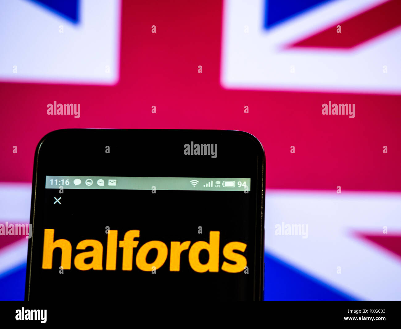 Halfords Group plc company logo seen displayed on smart phone Stock ...