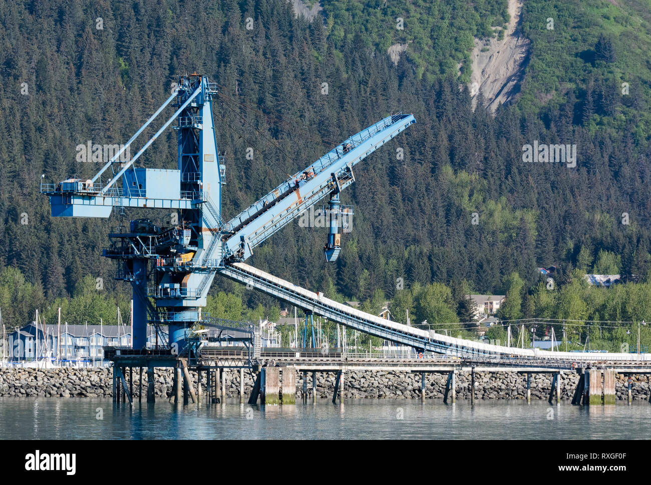Huge blue crane stands idle at empty dock in southern Alaska Stock ...
