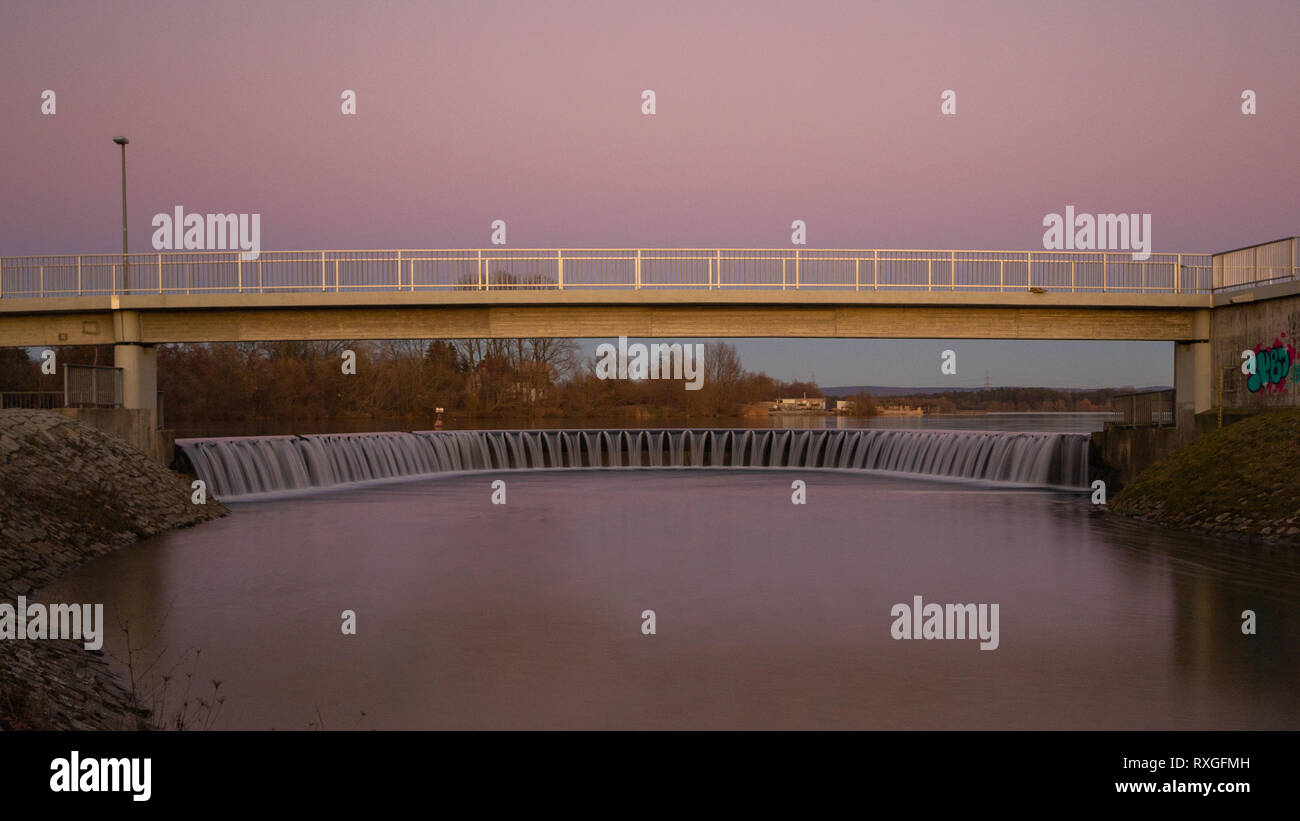 Long exposure of lake weir during sunset Stock Photo - Alamy